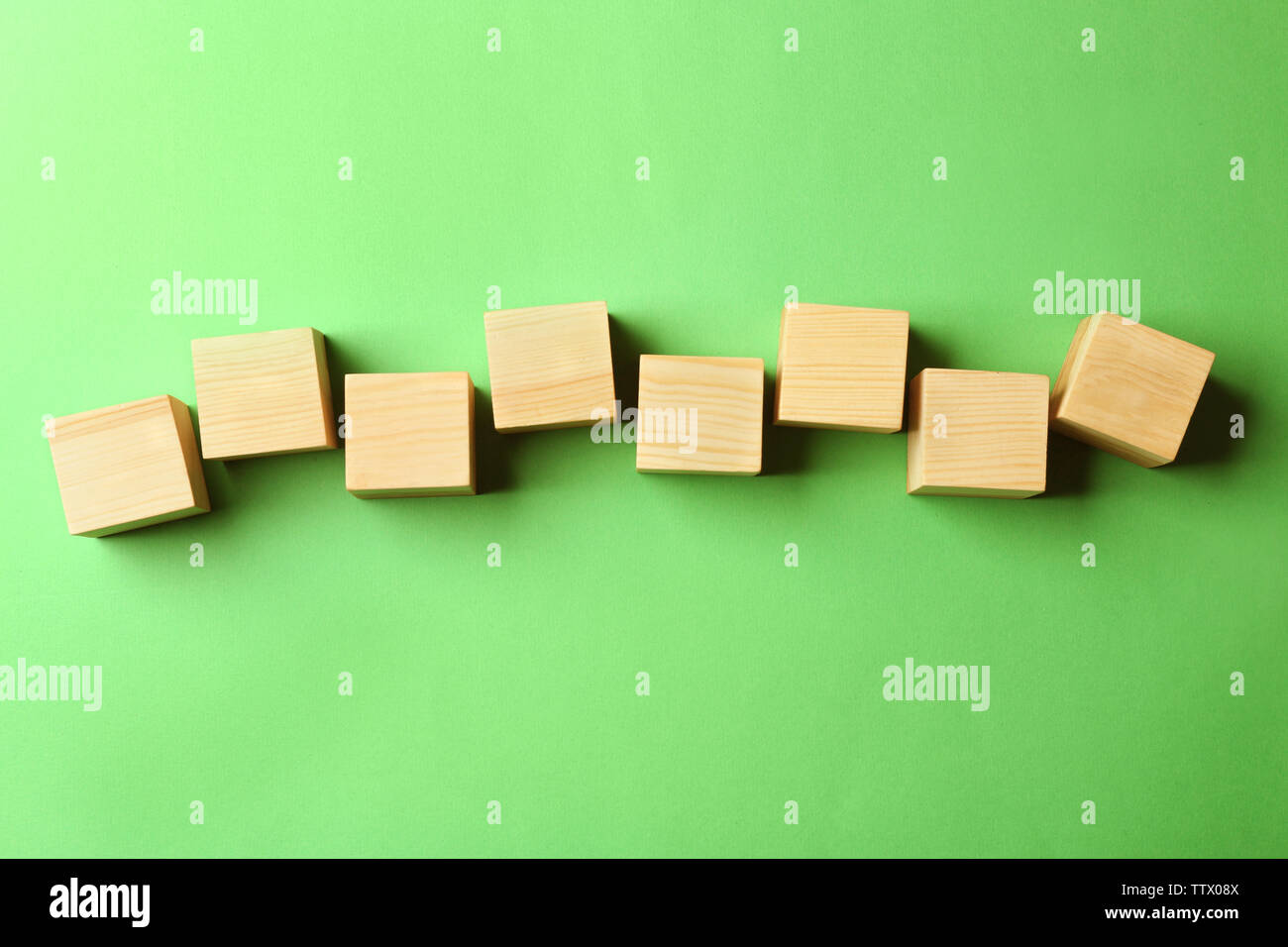 Empty wooden cubes on color background Stock Photo - Alamy