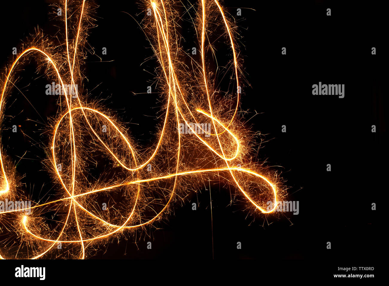 Sparkle firework writing sign/symbol on black background Stock Photo ...