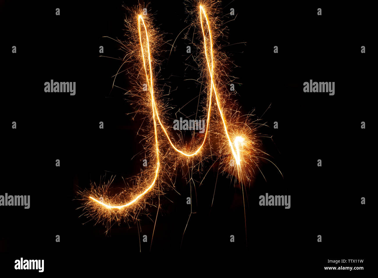 Sparkle firework writing font on black background Stock Photo - Alamy