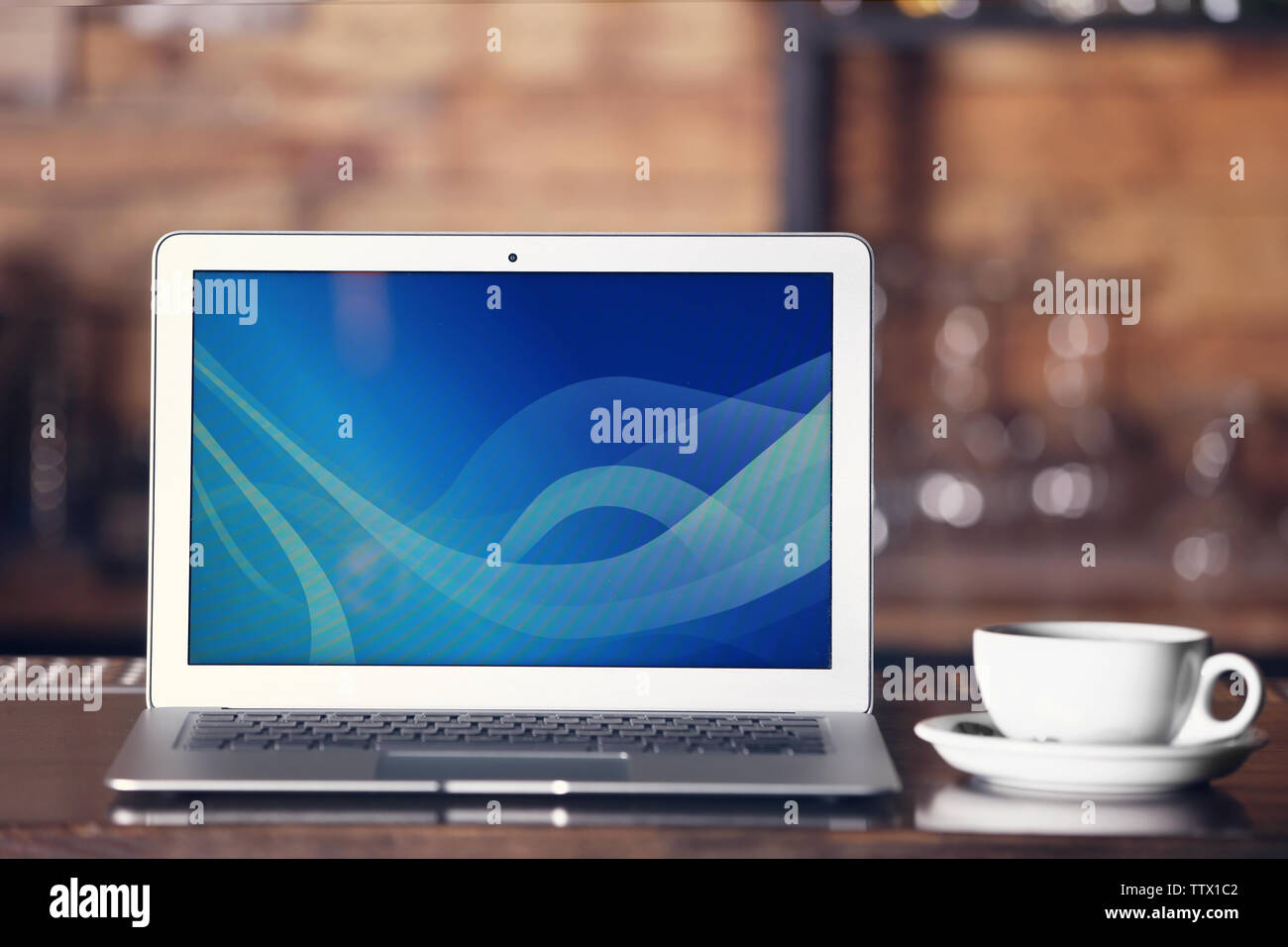 Modern laptop in cafe Stock Photo - Alamy