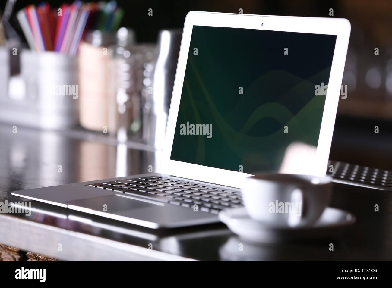 Modern laptop in cafe Stock Photo - Alamy