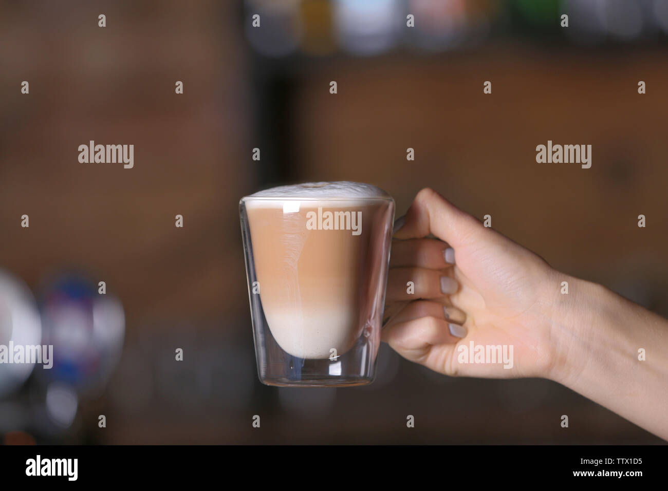 Female hand holding cup of hot coffee in cafe Stock Photo - Alamy