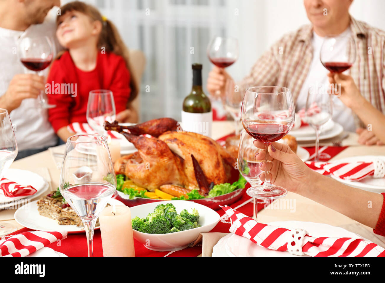 People sitting at table served for Thanksgiving dinner, close up view ...