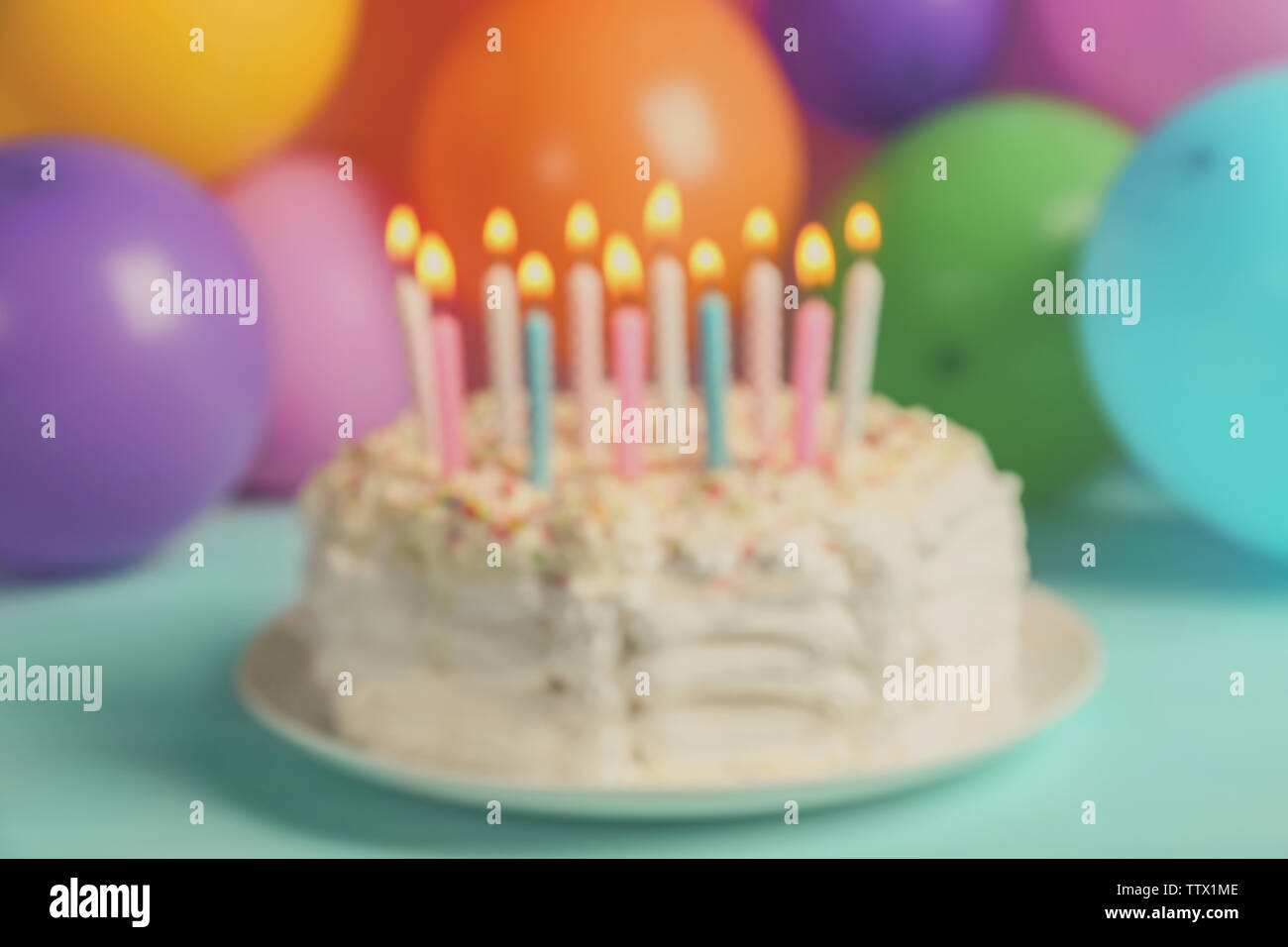 Blurred Birthday cake with candles on balloons background Stock Photo ...