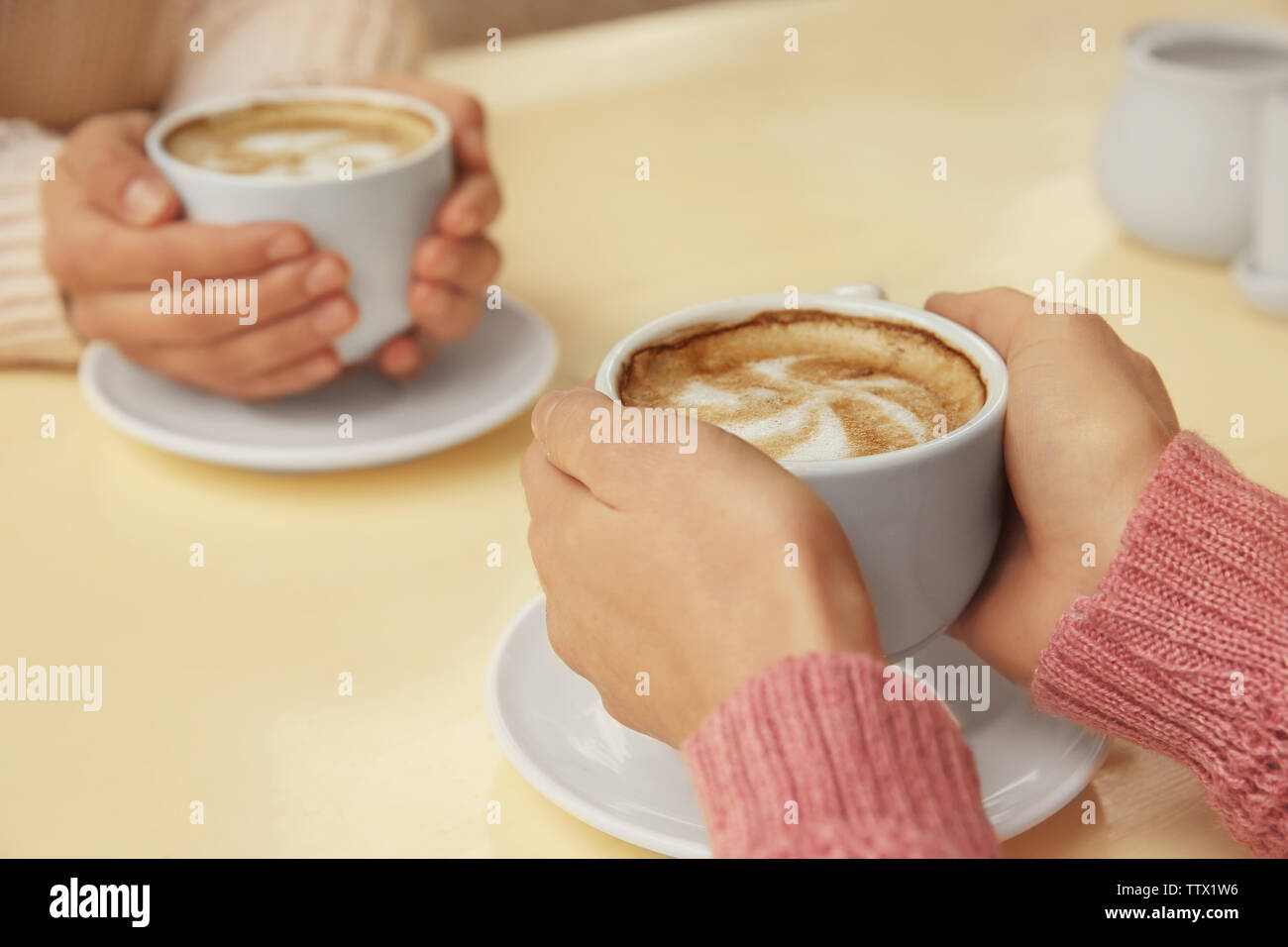 Female hands holding cups hi-res stock photography and images - Alamy