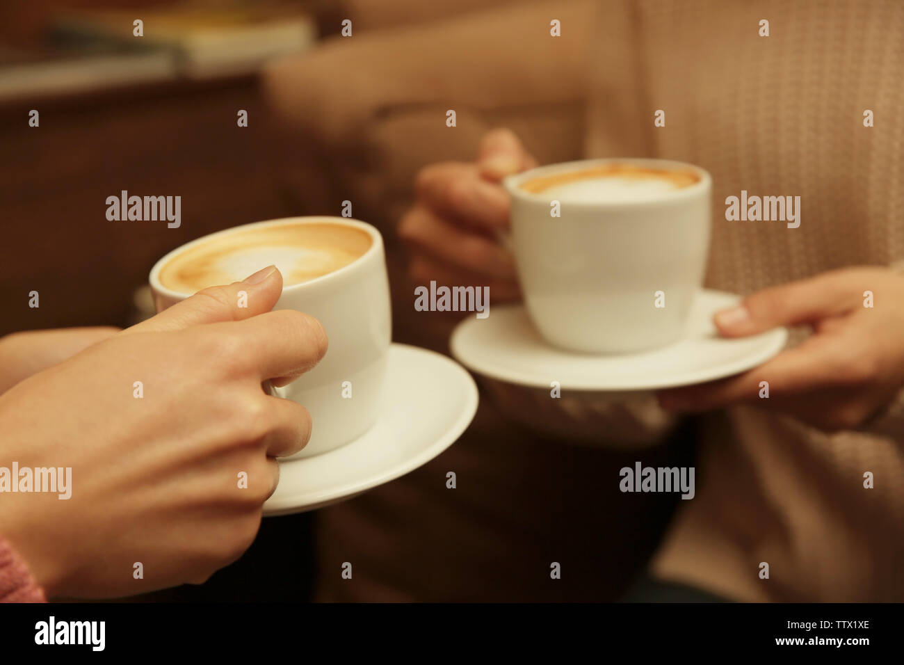 Hands holding cups hi-res stock photography and images - Alamy