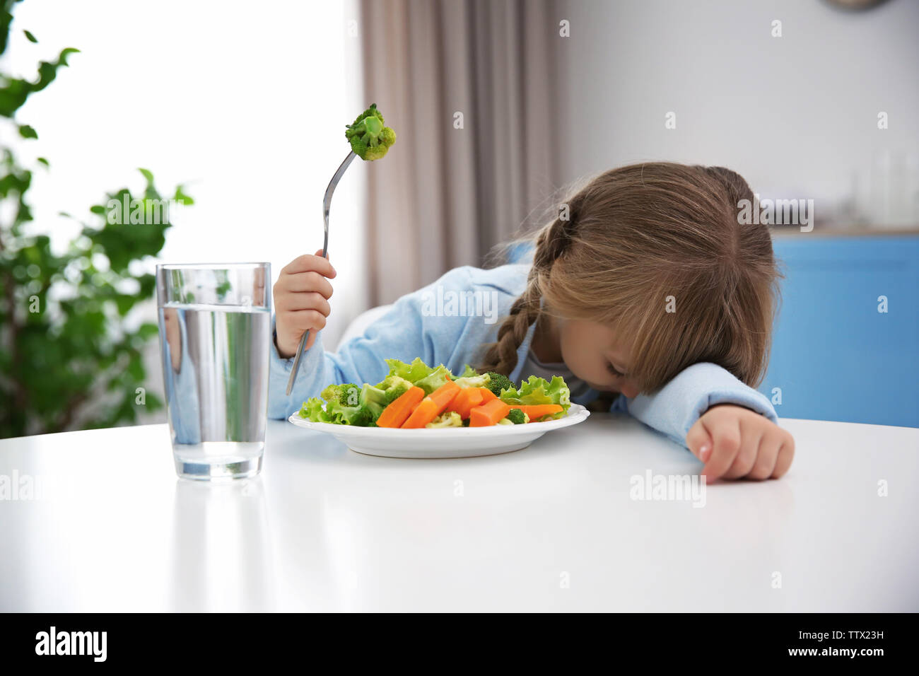 Small girl refusing to eat vegetable salad Stock Photo - Alamy