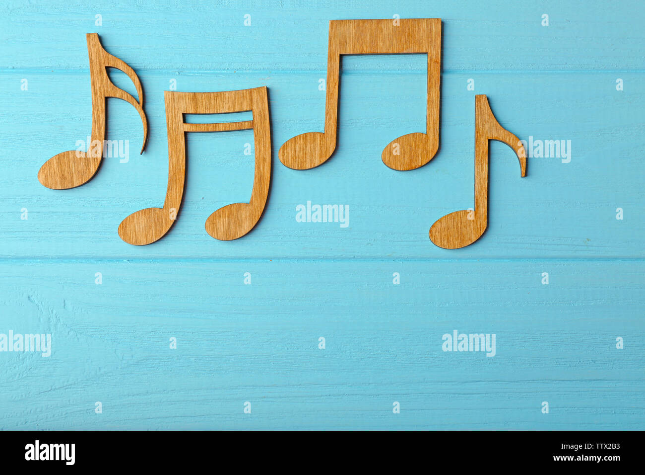 Music notes on color wooden background Stock Photo - Alamy