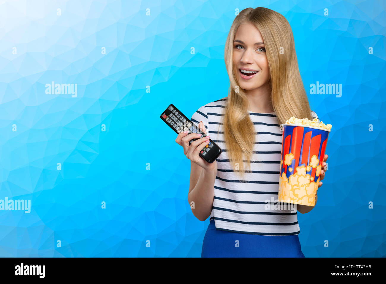 girl eating popcorn and watching tv Stock Photo - Alamy