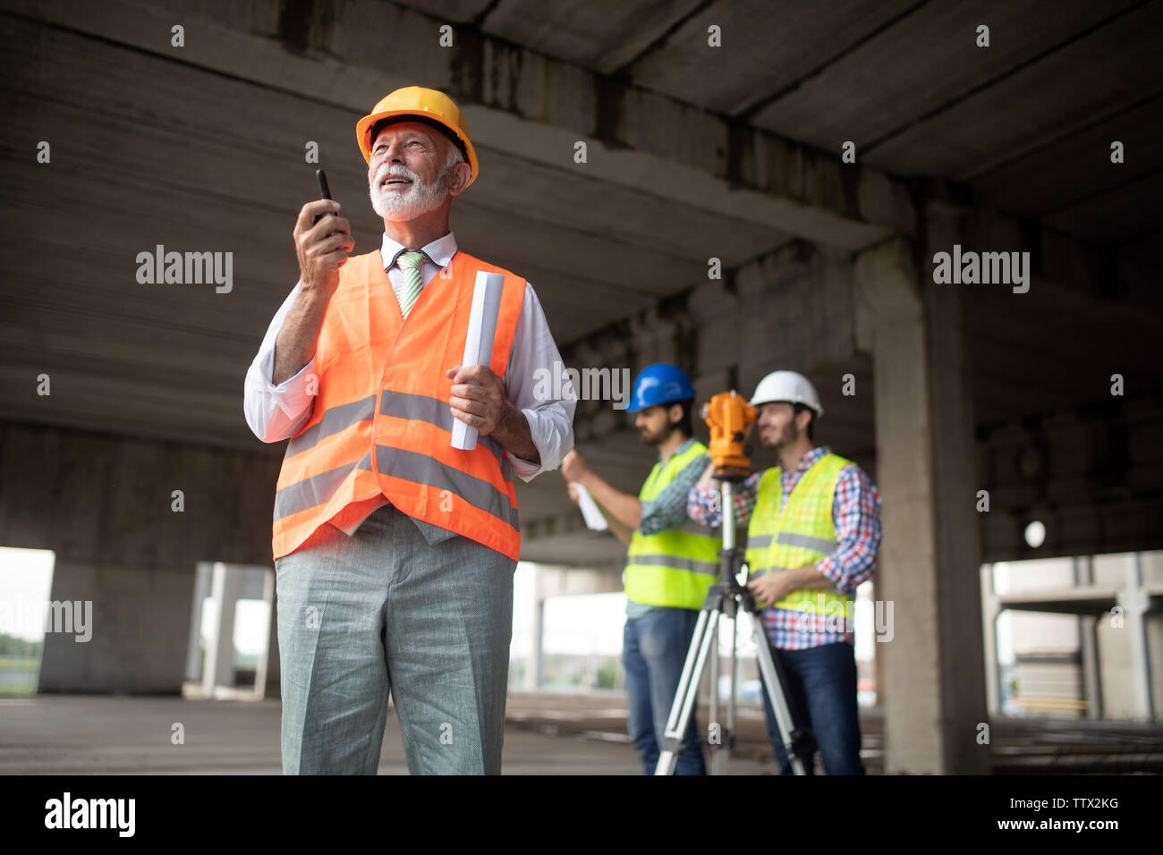 Team of architects and engineer in group on construciton site check ...