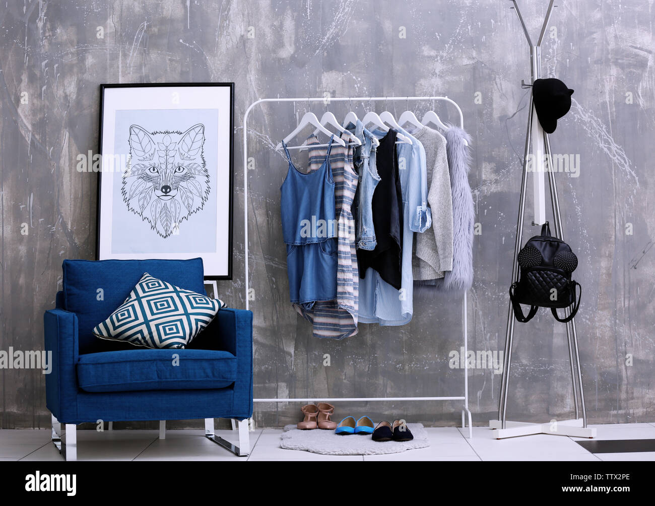 Fashionable clothes hanging on rack at modern dressing room Stock Photo ...