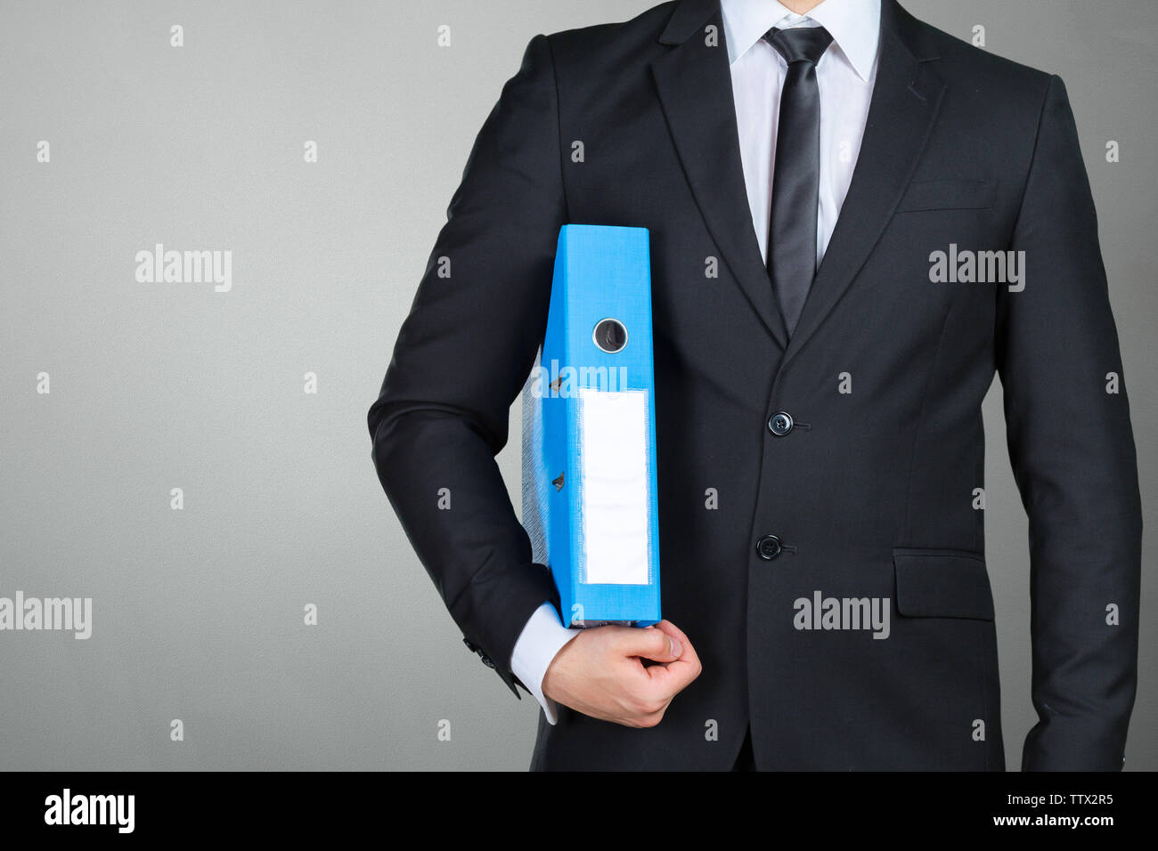 Confident businessman holding a document folder Stock Photo - Alamy