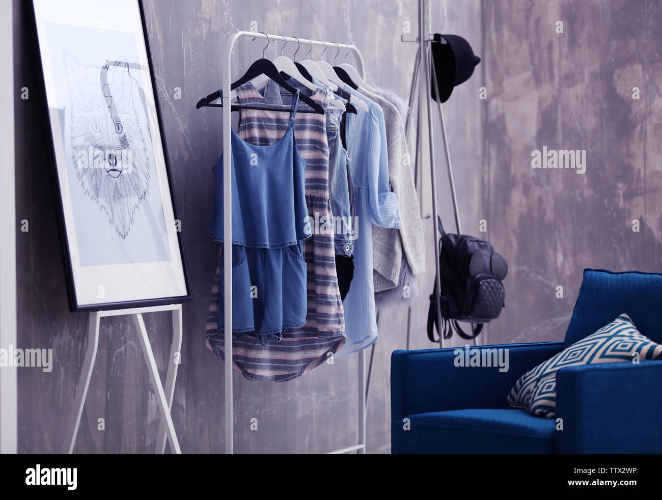 Fashionable clothes hanging on rack at modern dressing room Stock Photo ...