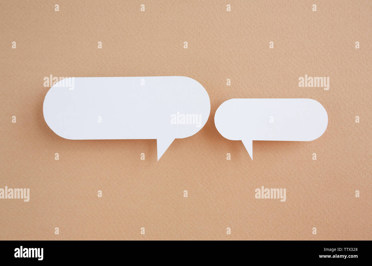 paper speech bubbles on brown background Stock Photo - Alamy