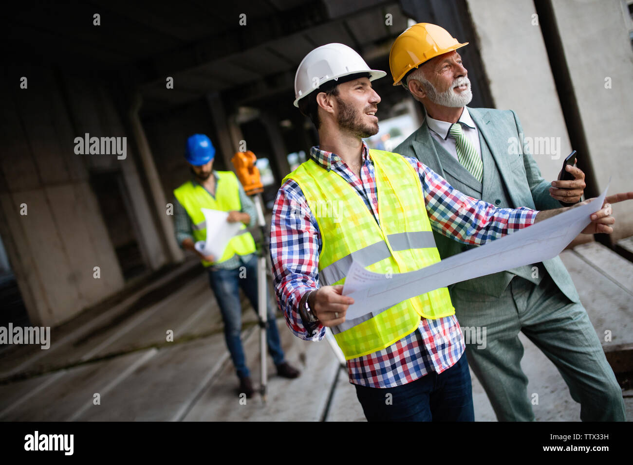 Construction engineers discussion with architects at construction or ...