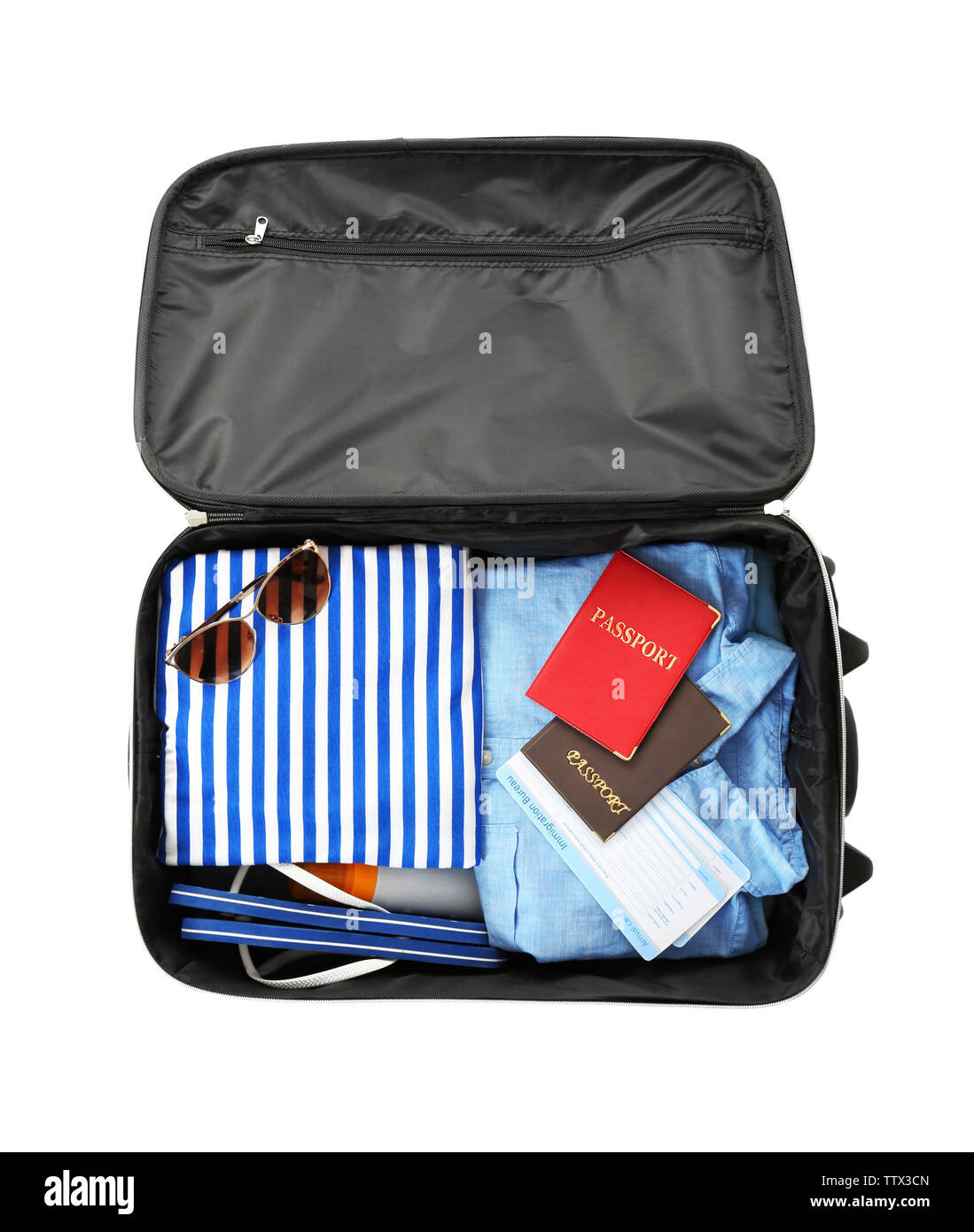 Open suitcase with traveller set on white background Stock Photo - Alamy