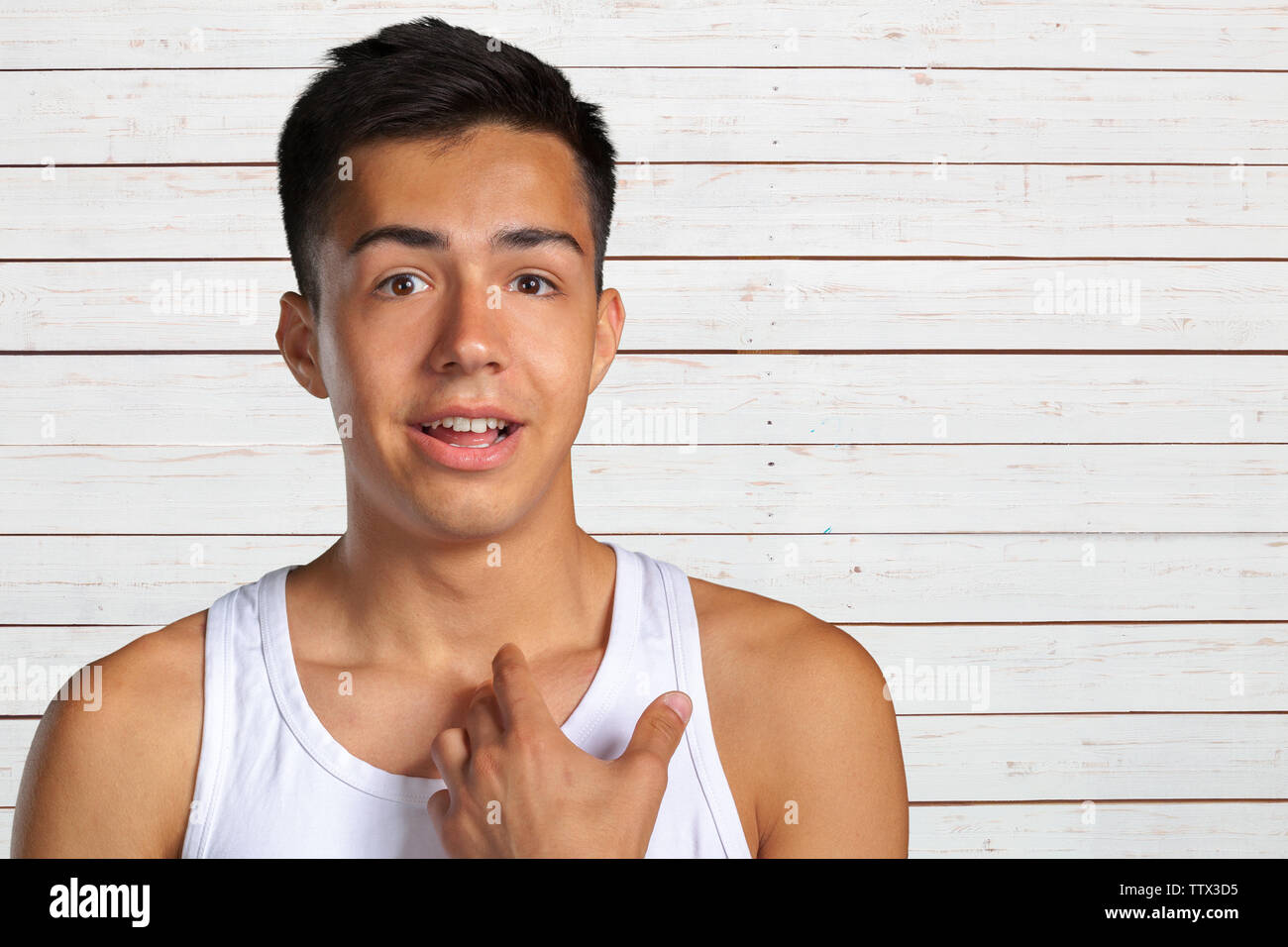 unhappy young guy pointing at himself asking you mean me Stock Photo ...