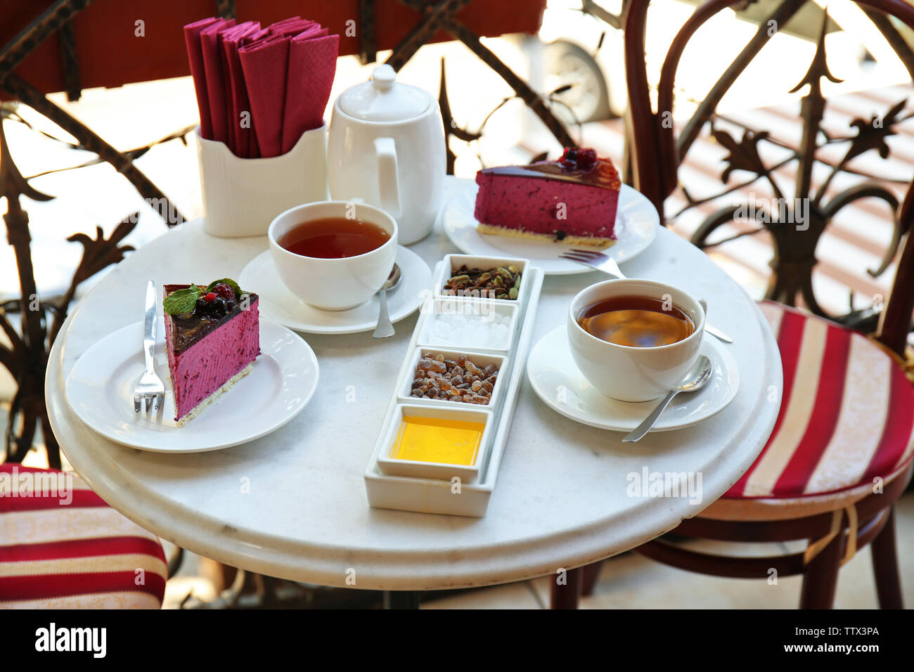 Modern cafe table with tea and cake Stock Photo - Alamy