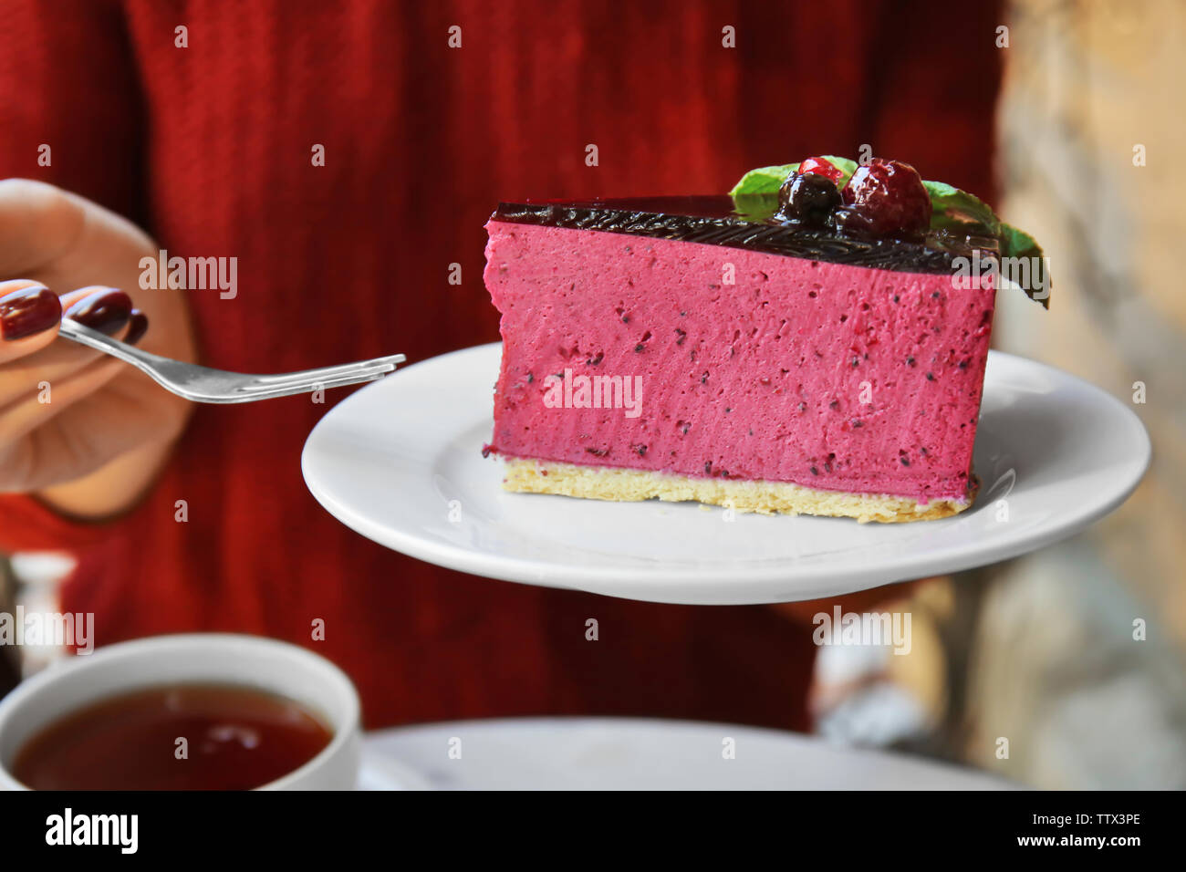 Woman eating delicious cake in cafe Stock Photo - Alamy