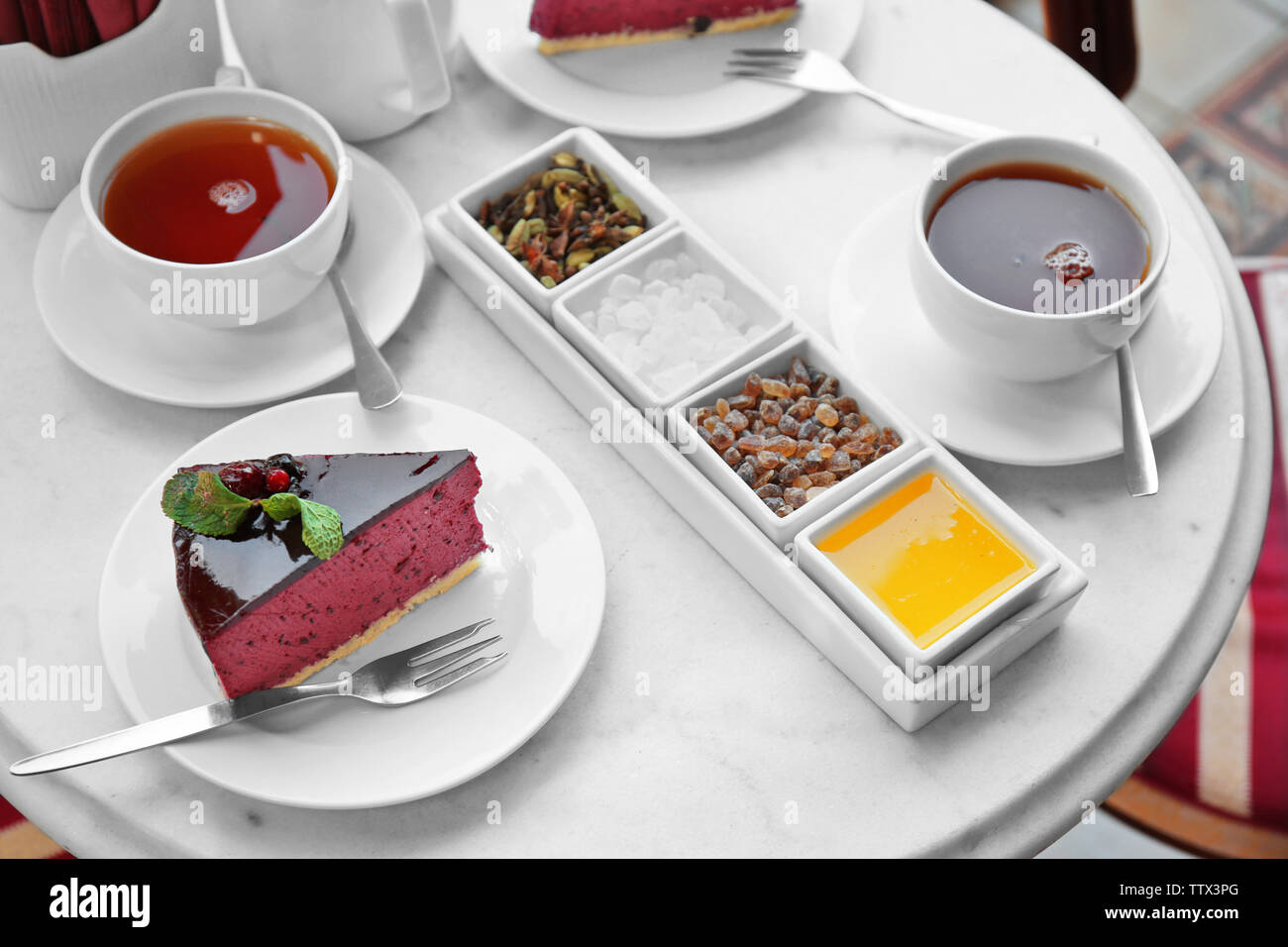 Modern cafe table with tea and cake Stock Photo - Alamy