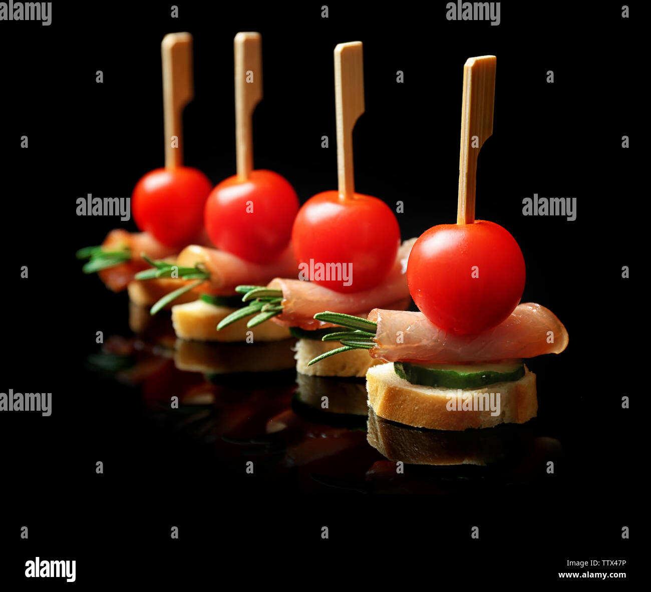 Set of delicious canapes on black background Stock Photo - Alamy