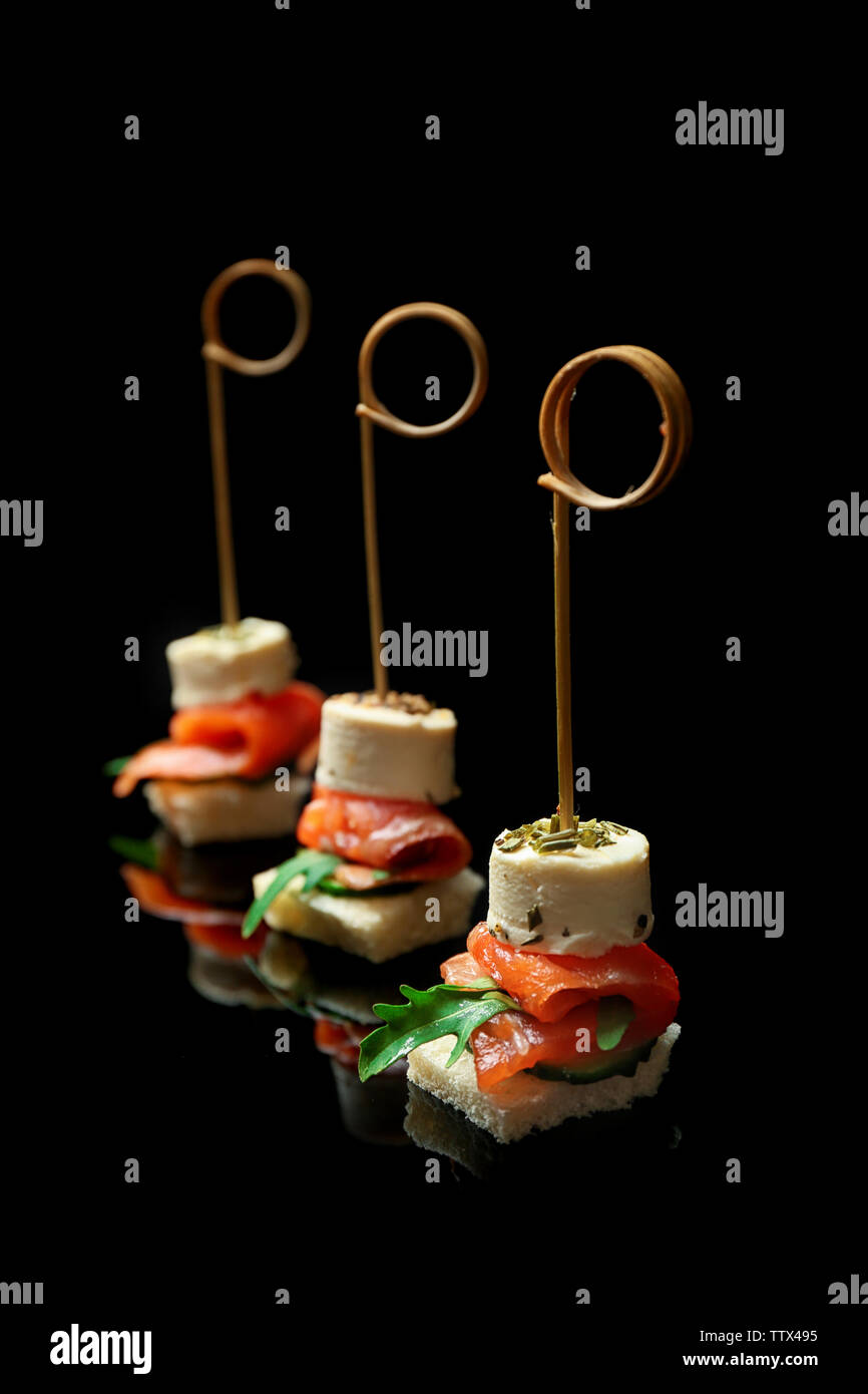 Gourmet canapes on black background Stock Photo - Alamy