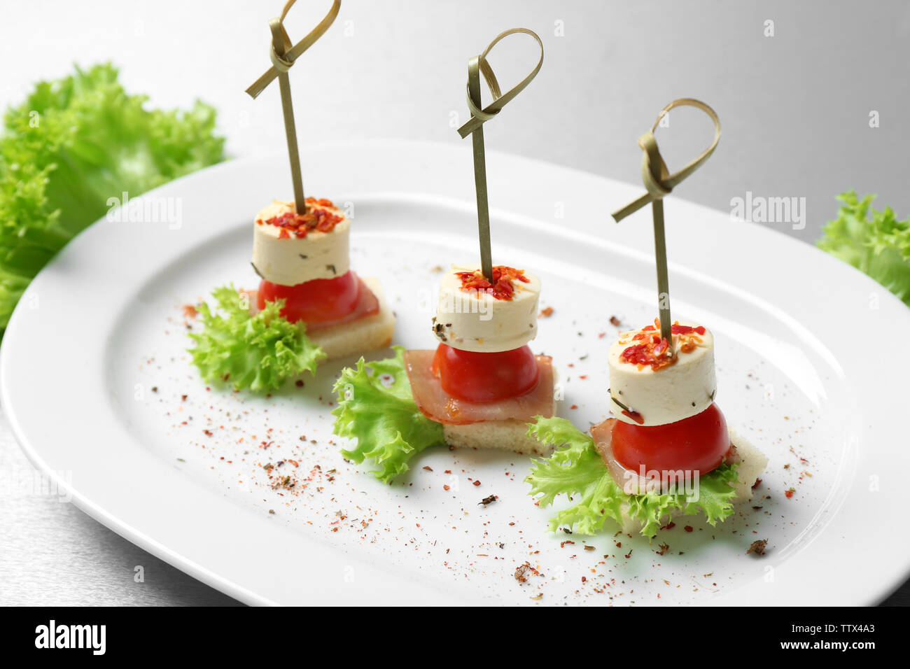 Set of delicious canapes on white plate closeup Stock Photo - Alamy