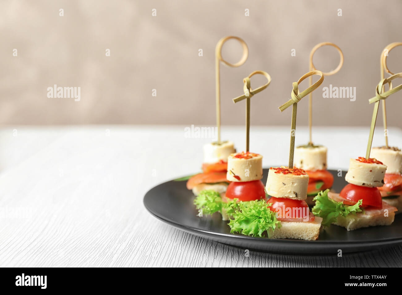 Delicious canapes on white table closeup Stock Photo - Alamy