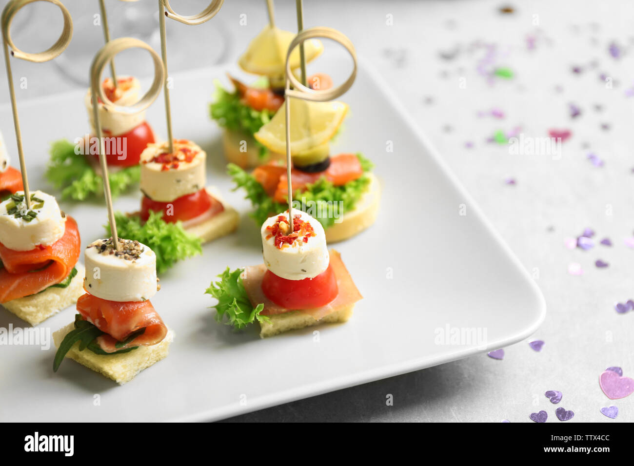 Assorted canapes on table closeup Stock Photo - Alamy