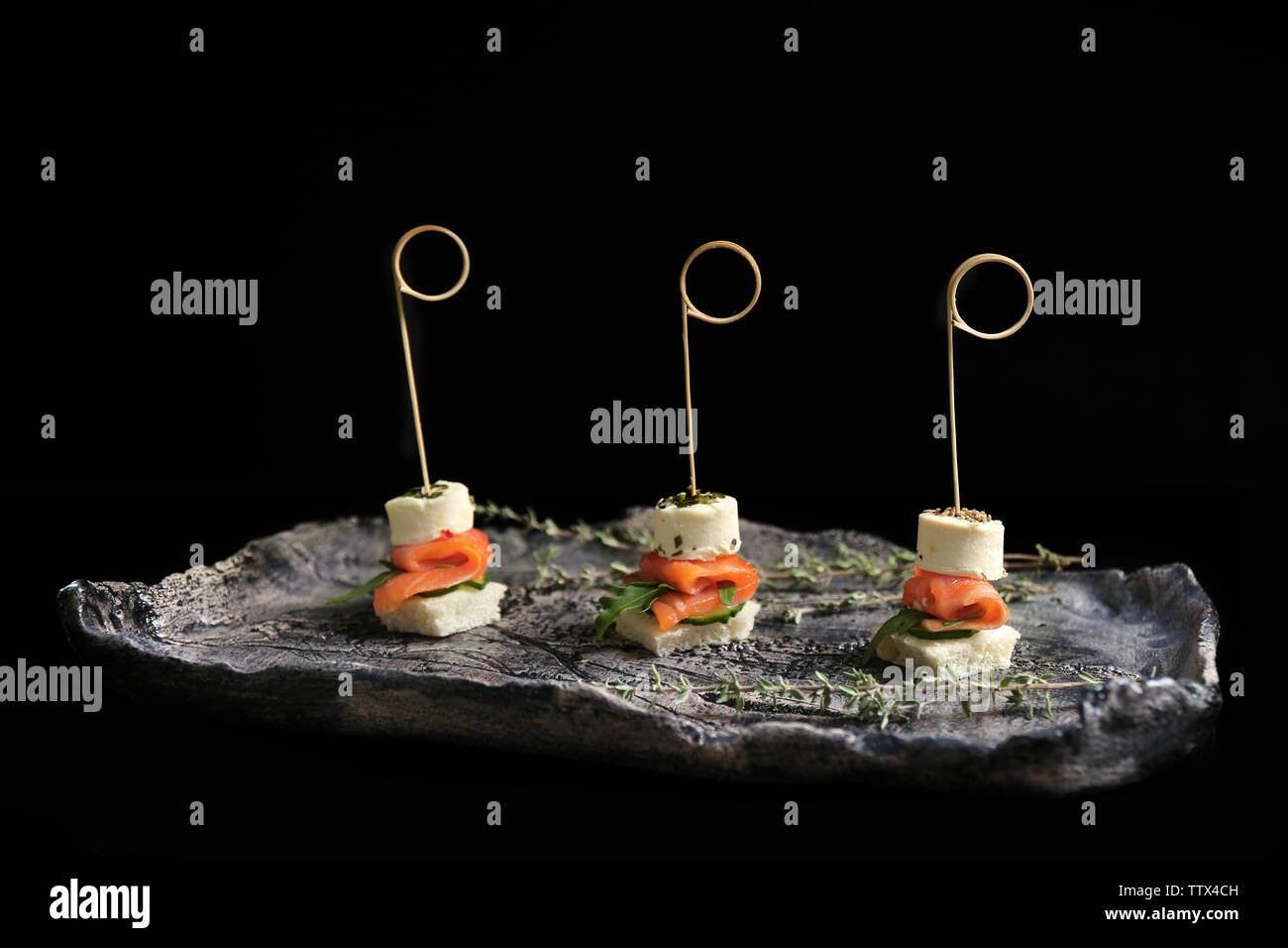 Delicious canapes on black background Stock Photo - Alamy