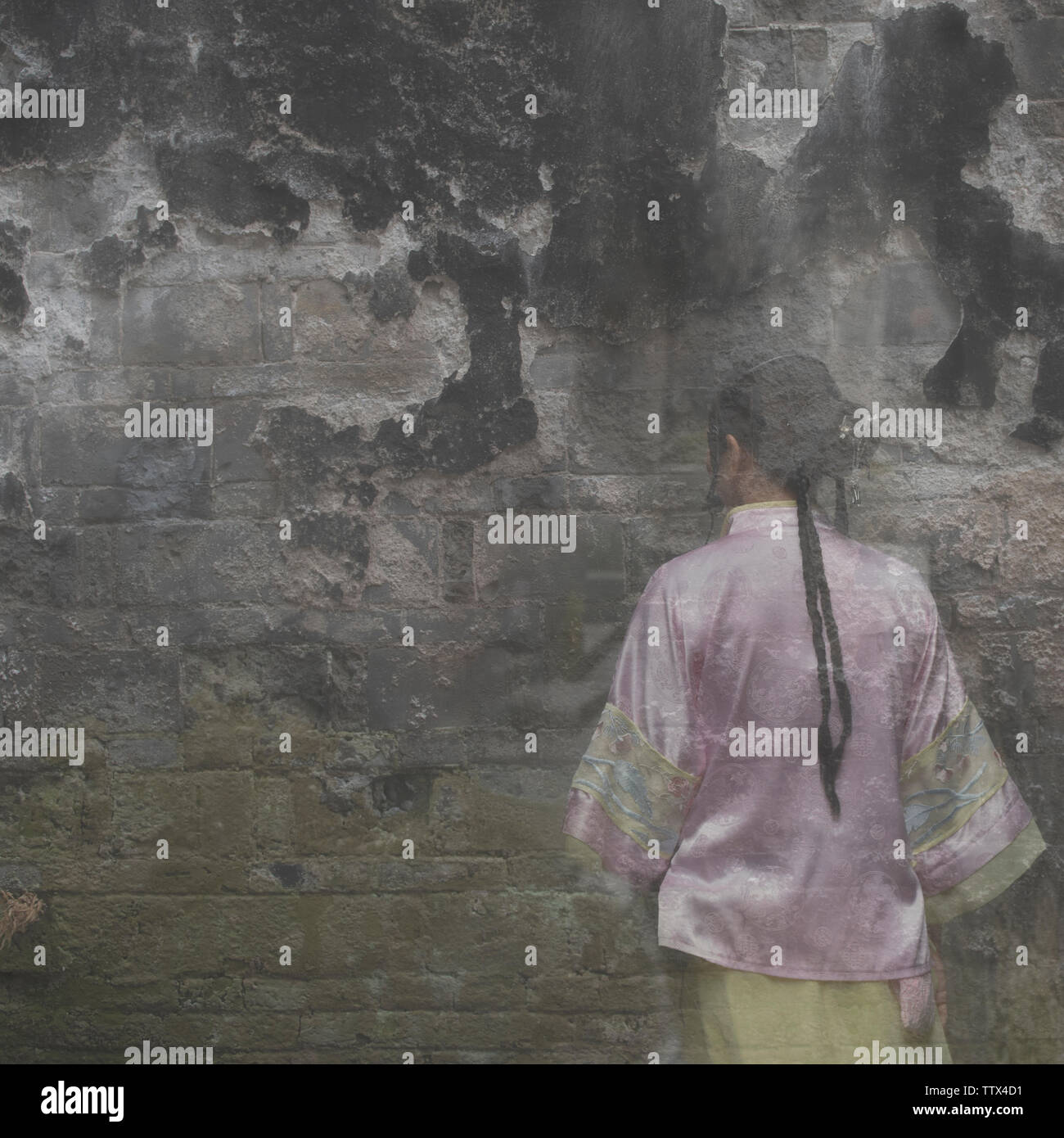 Grey wall and maiden Stock Photo - Alamy