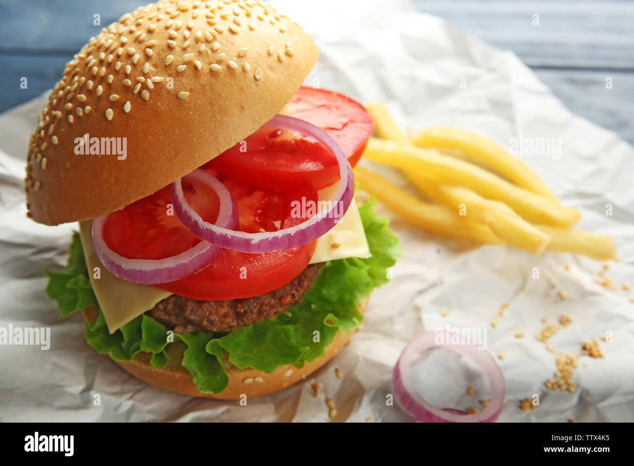 Delicious cheeseburger on paper background Stock Photo - Alamy