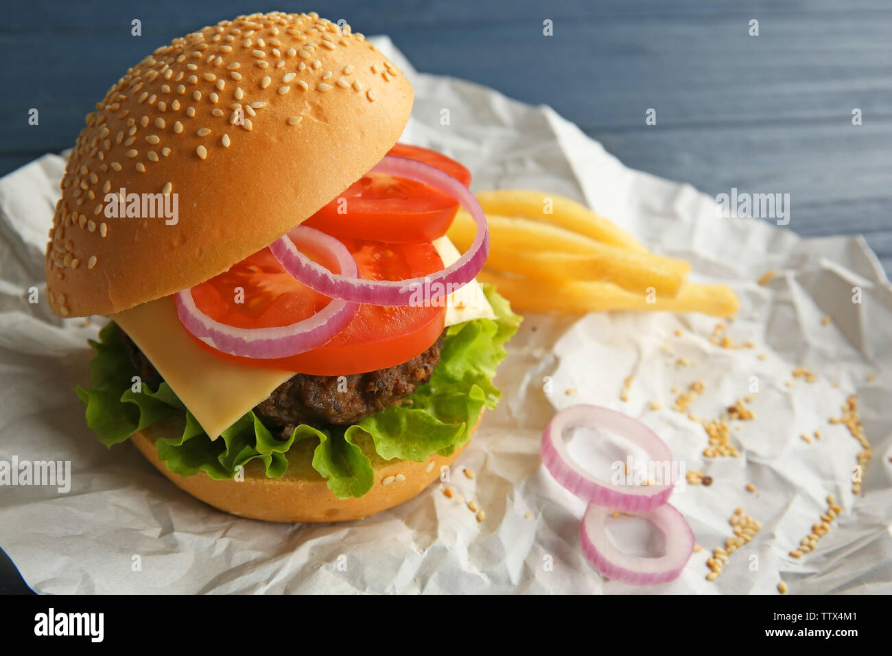 Delicious cheeseburger on paper background Stock Photo - Alamy