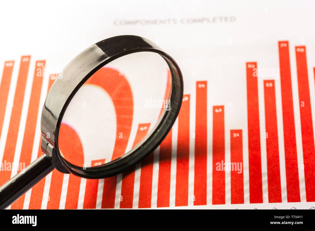 Magnifying glass and business growth graph Stock Photo - Alamy