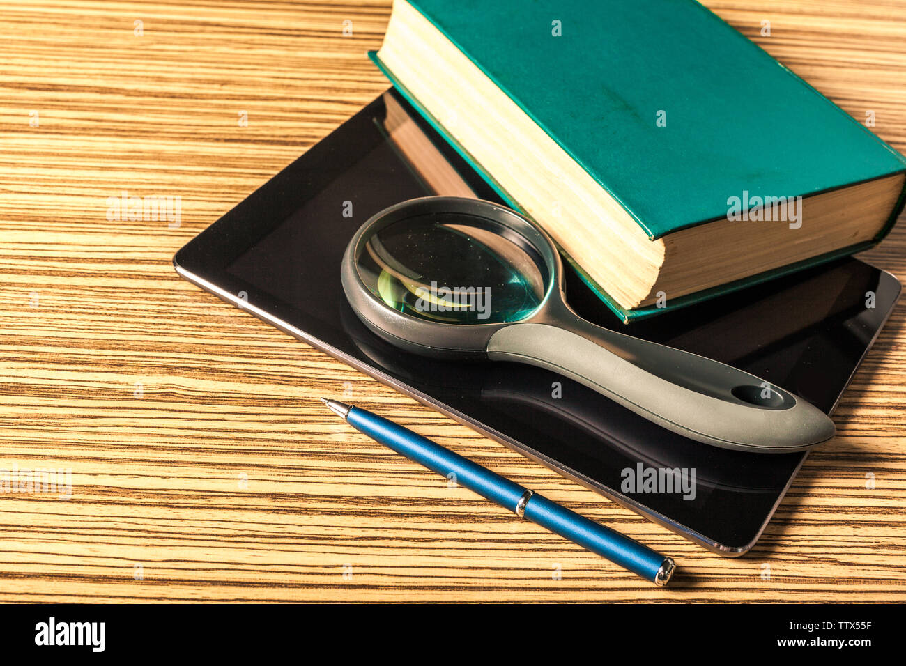 books and magnifying glass Stock Photo - Alamy