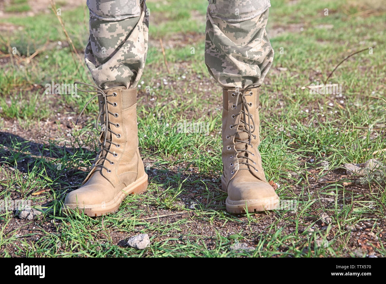 Feet of soldier standing at military firing range, close up view Stock ...