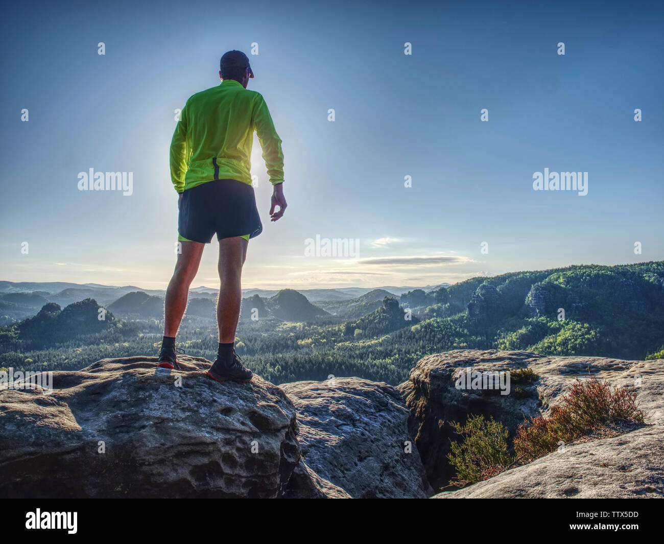 Trail runner athlete man. Slim person training in mountains in cold ...