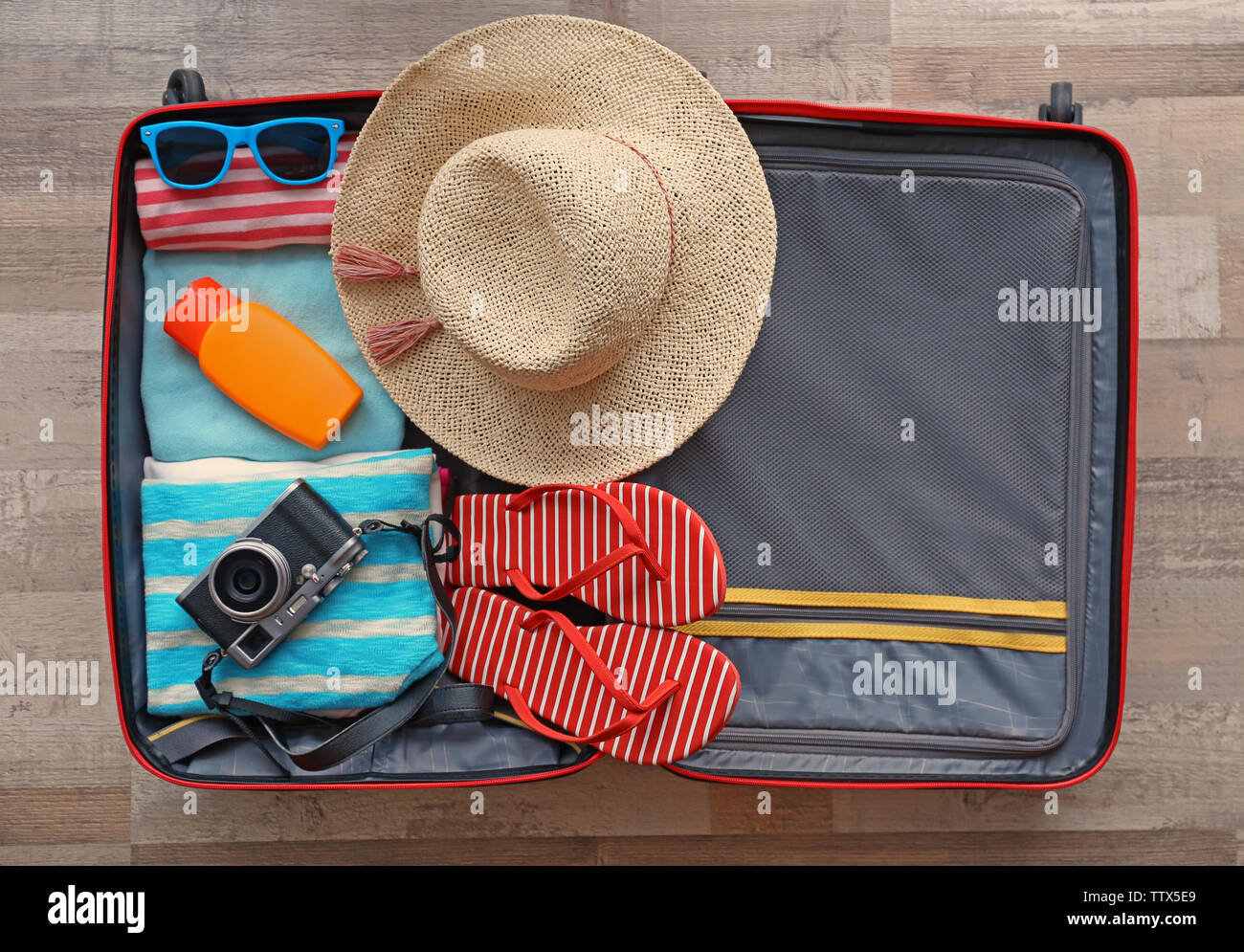 Open suitcase packed for travelling, close up Stock Photo - Alamy