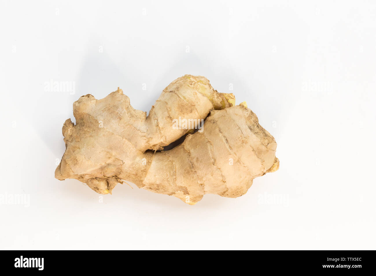 Ginger and cut ginger slices on white background Stock Photo - Alamy