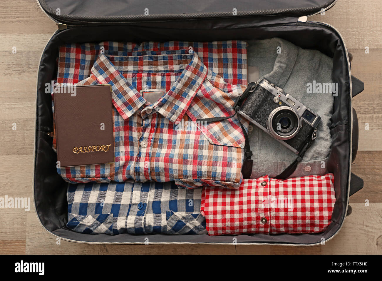 Open suitcase packed for travelling, close up Stock Photo - Alamy