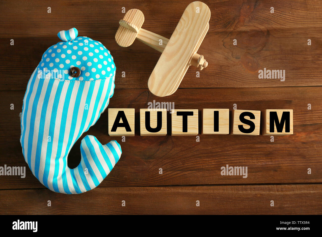 Cubes with space for text and toys on wooden background, top view ...