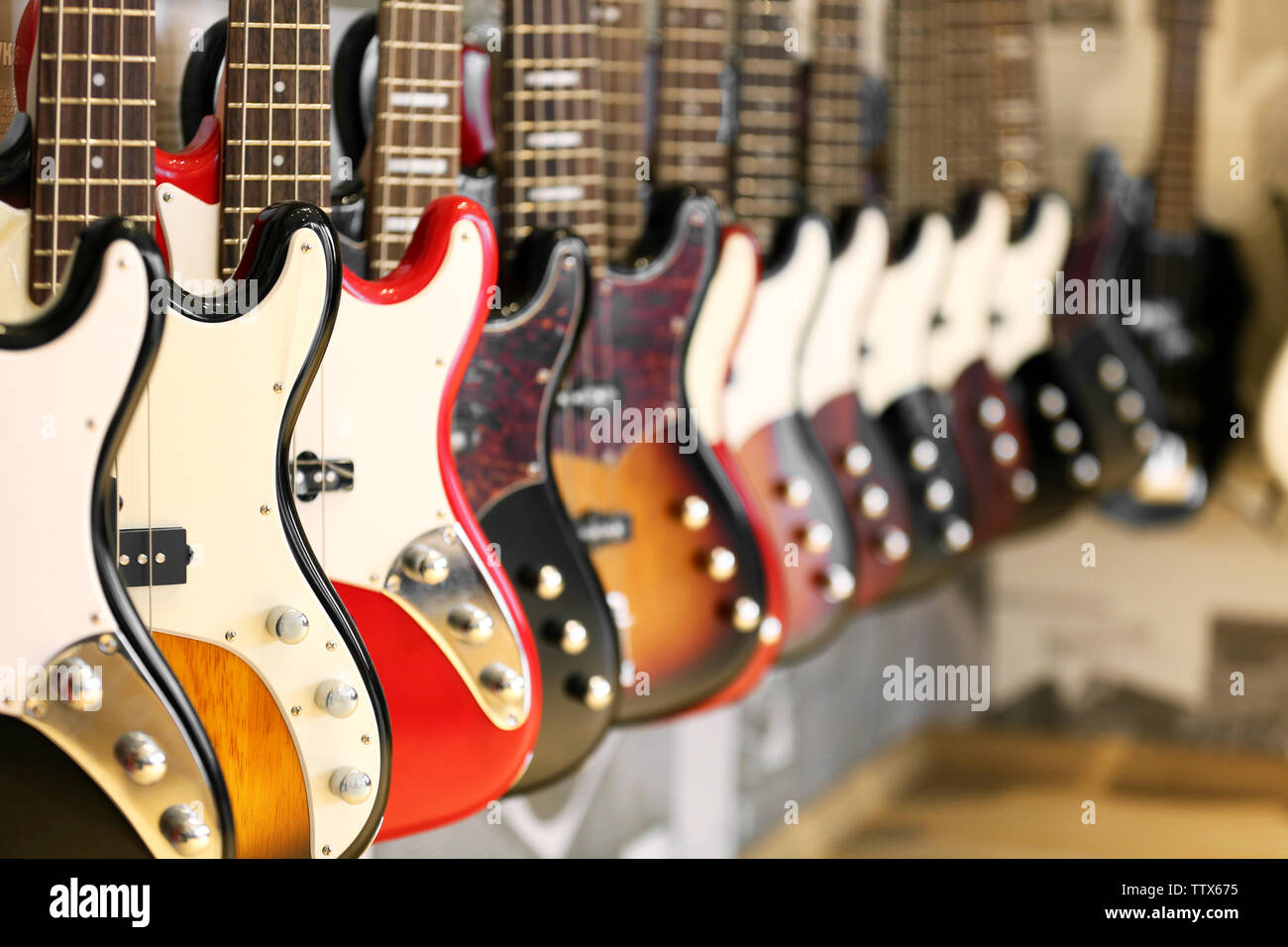 Guitars in music shop Stock Photo - Alamy