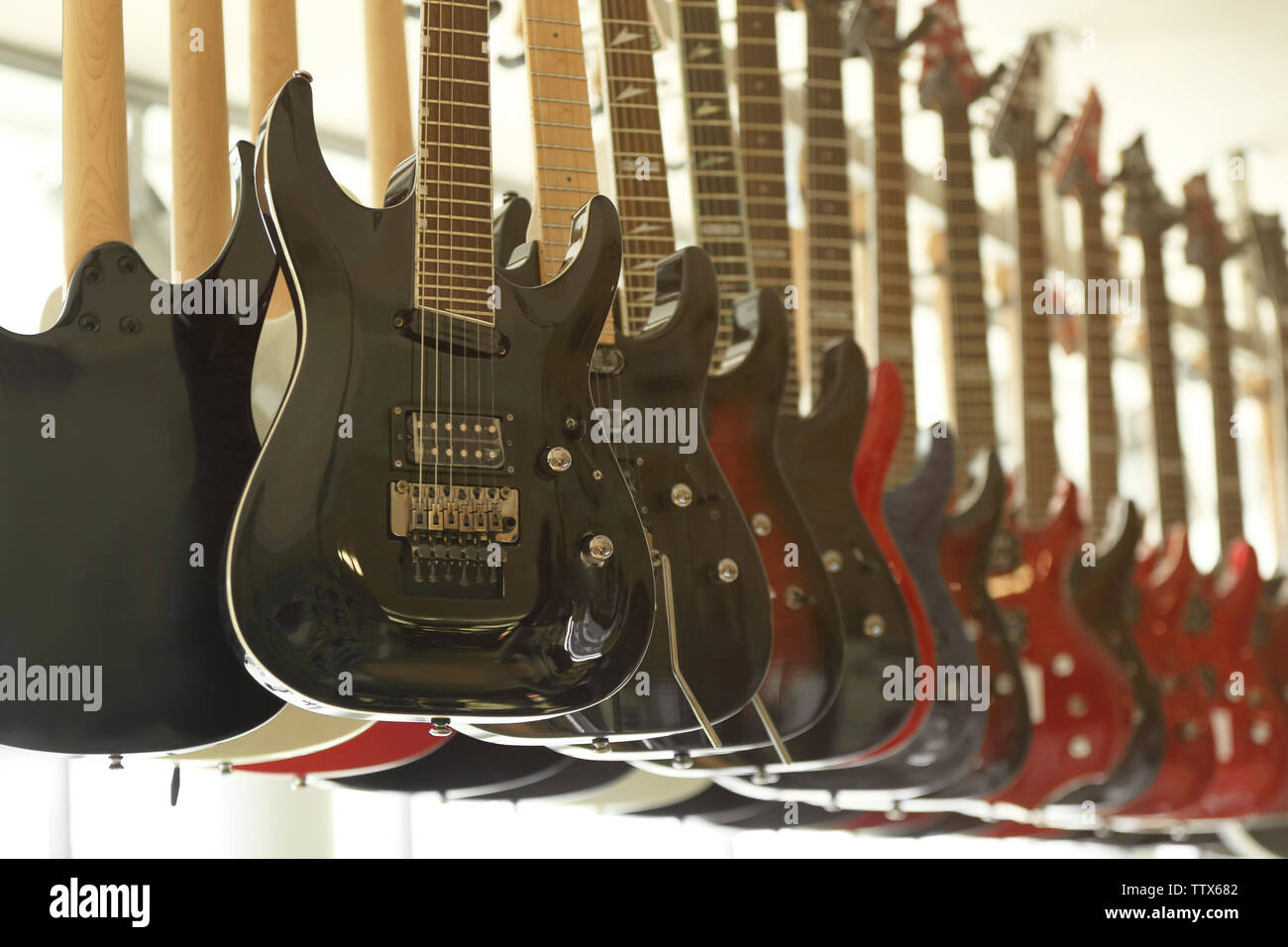 Guitars in music shop Stock Photo - Alamy