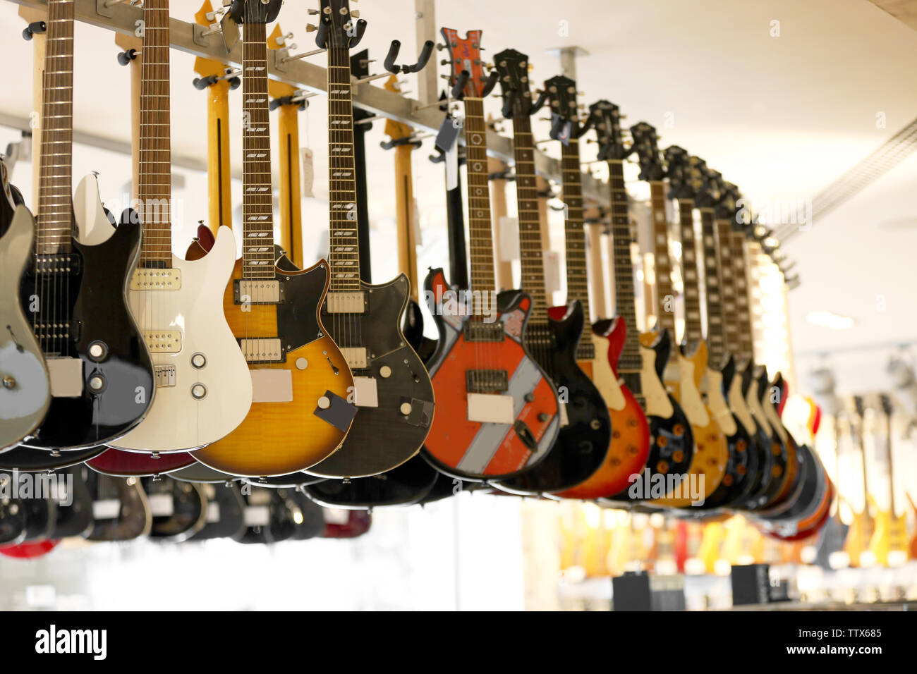 Guitars in music shop Stock Photo - Alamy