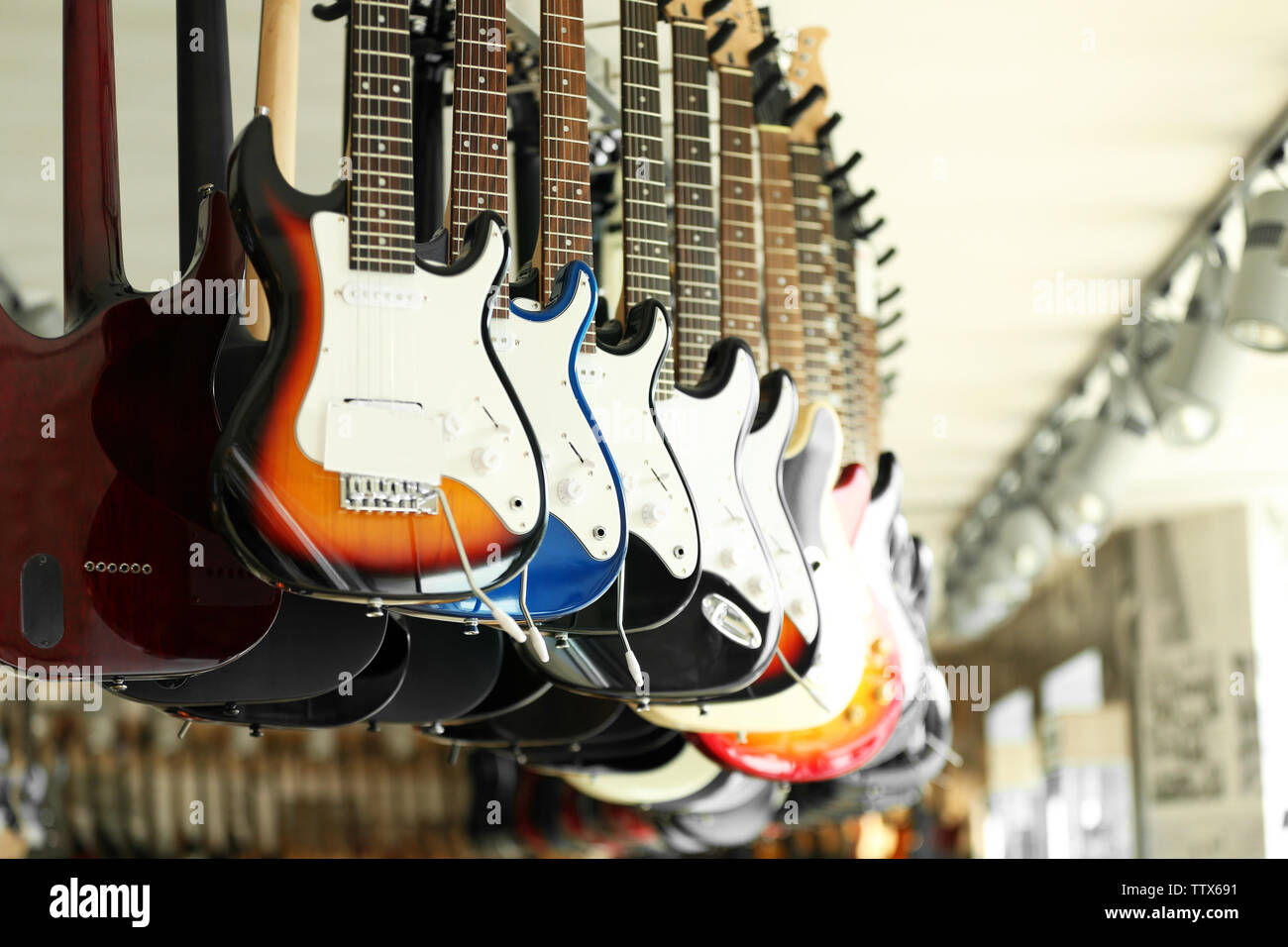 Guitars in music shop Stock Photo - Alamy