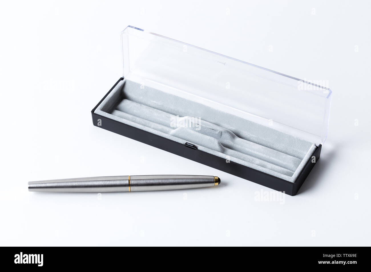 Pen in box on white background Stock Photo - Alamy
