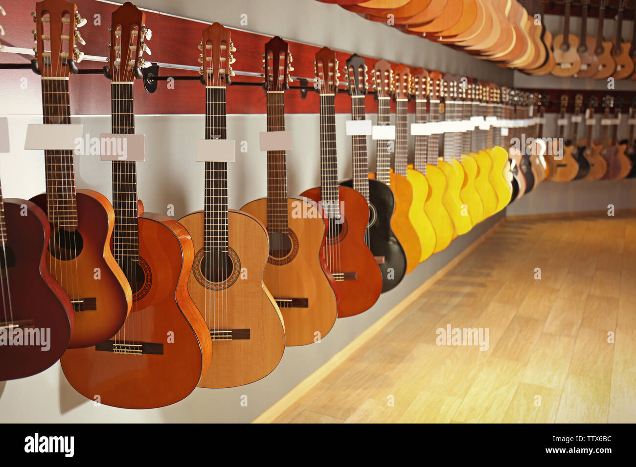 Guitars in music shop Stock Photo - Alamy