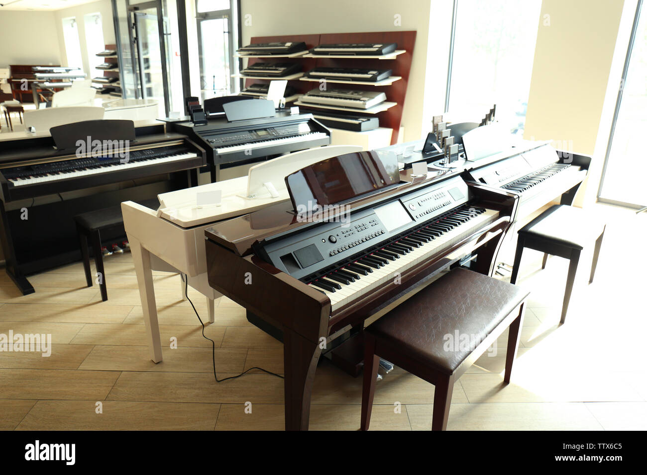 Piano in music shop Stock Photo - Alamy