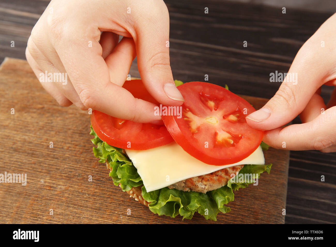 Female cooking burger hi-res stock photography and images - Alamy