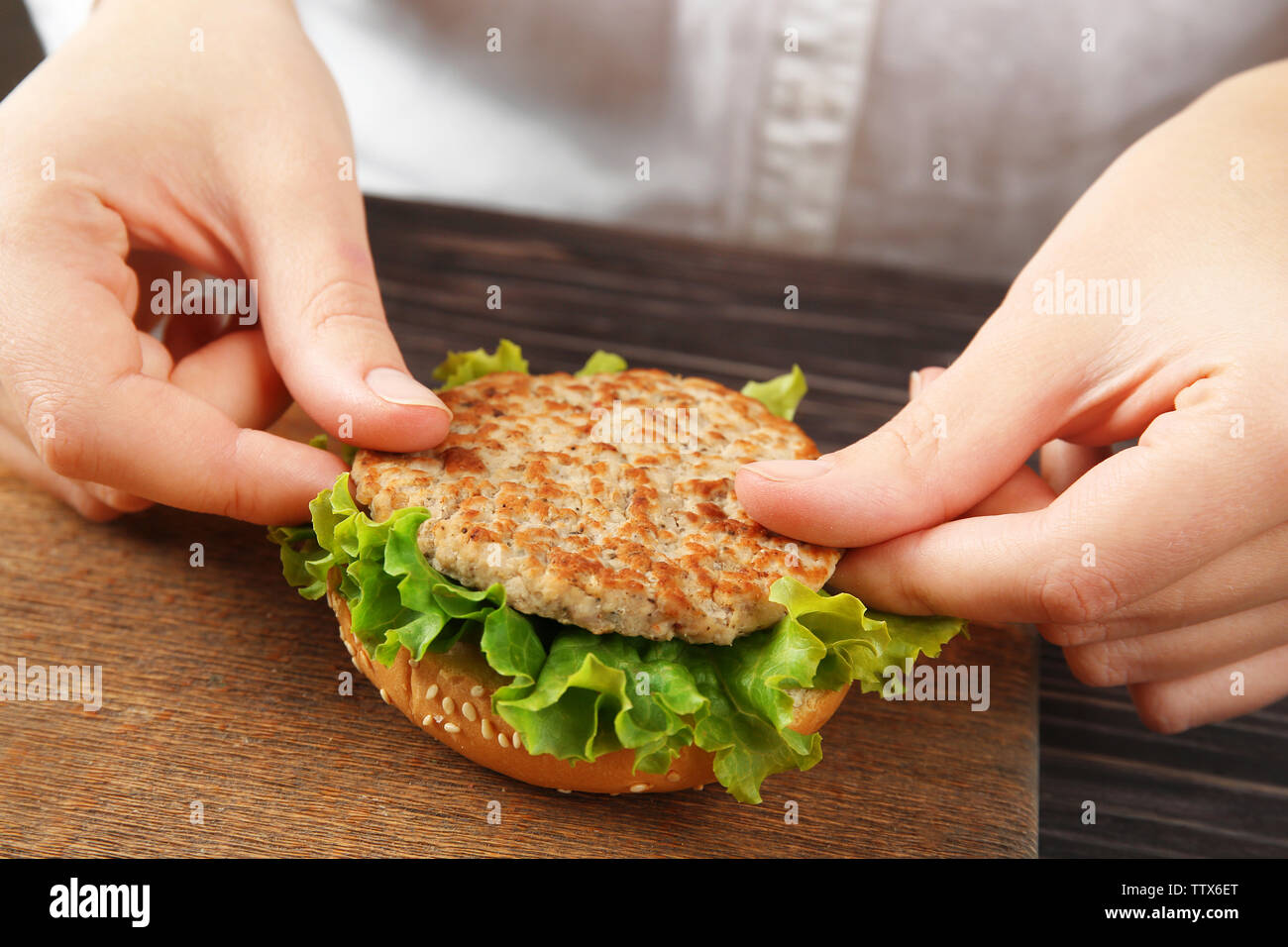 Female cooking burger hi-res stock photography and images - Alamy